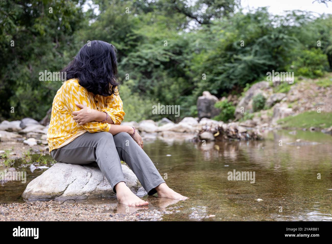 Isolated Girl Sitting Alone on Stone at Calm Lake Shore in the Morning ...