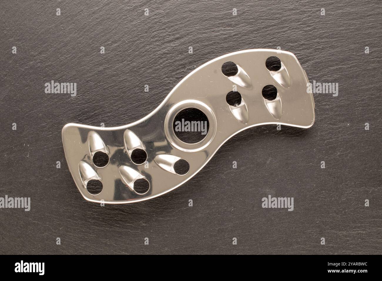 One metal mixer knife on slate stone, macro, top view Stock Photo - Alamy