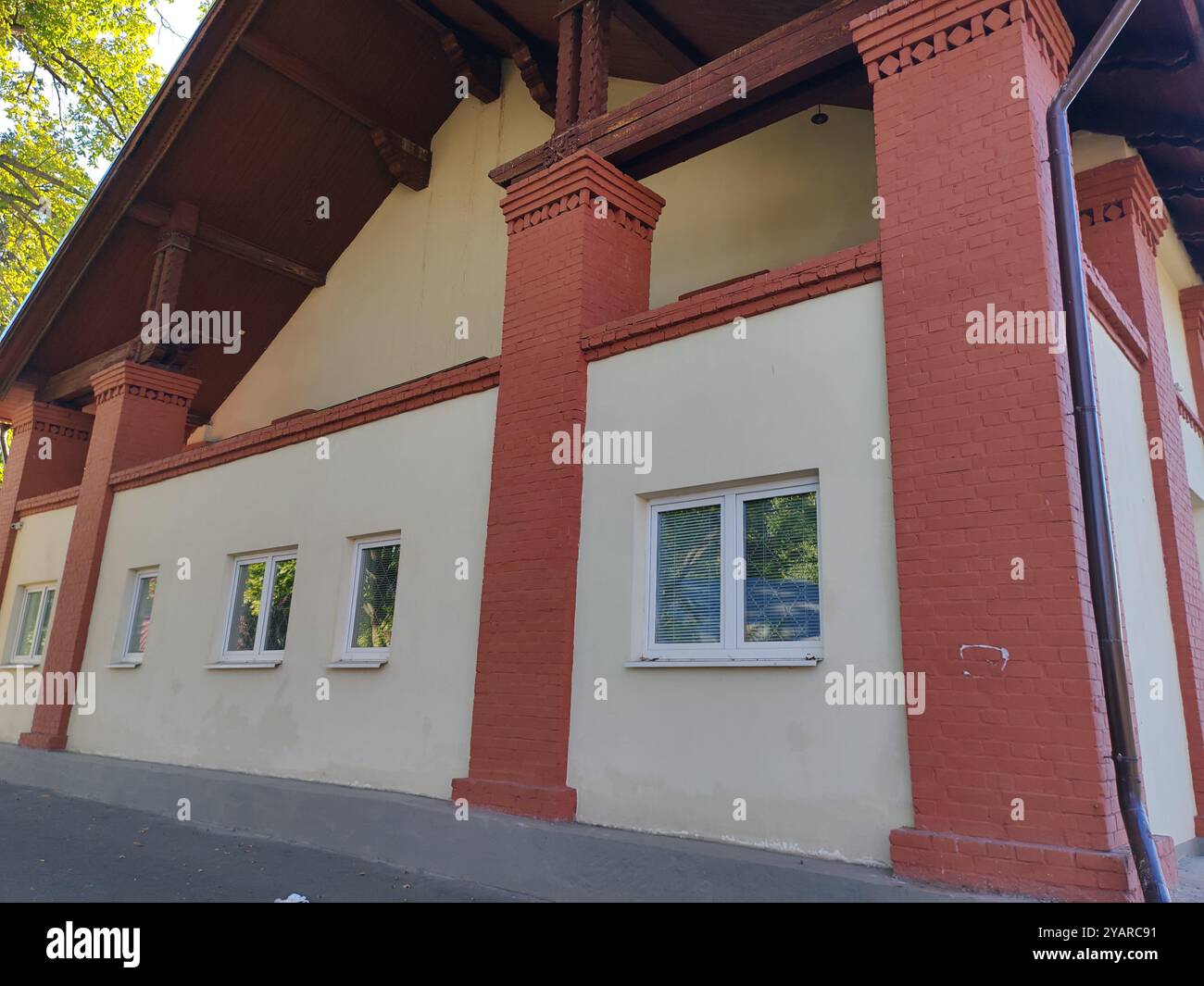 A vintage building with distinctive red brick columns and a spacious ...