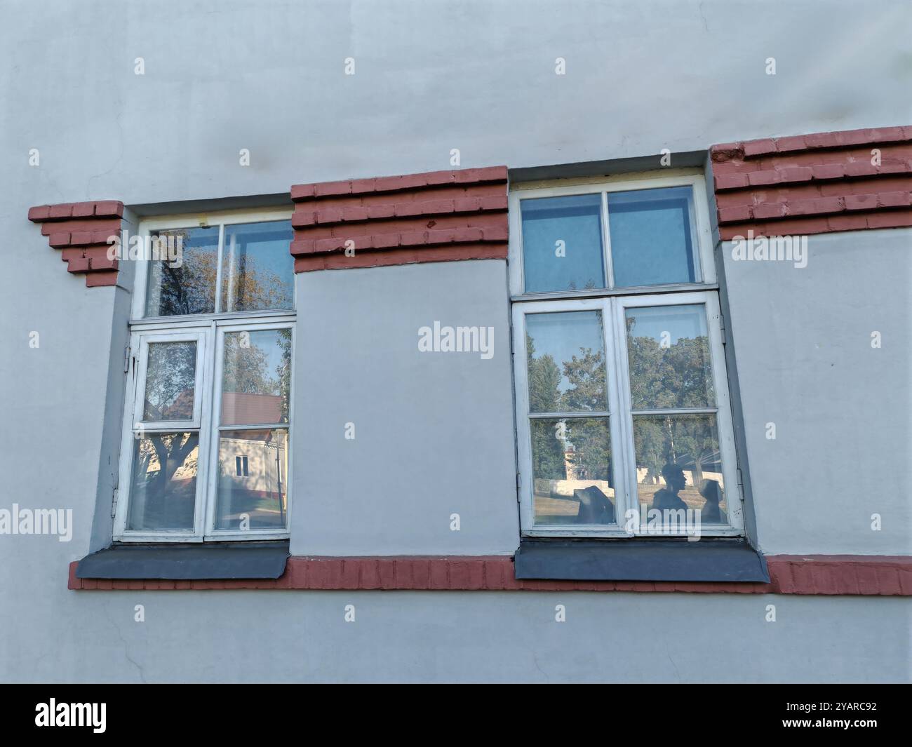 A vintage building with distinctive red brick columns and a spacious ...