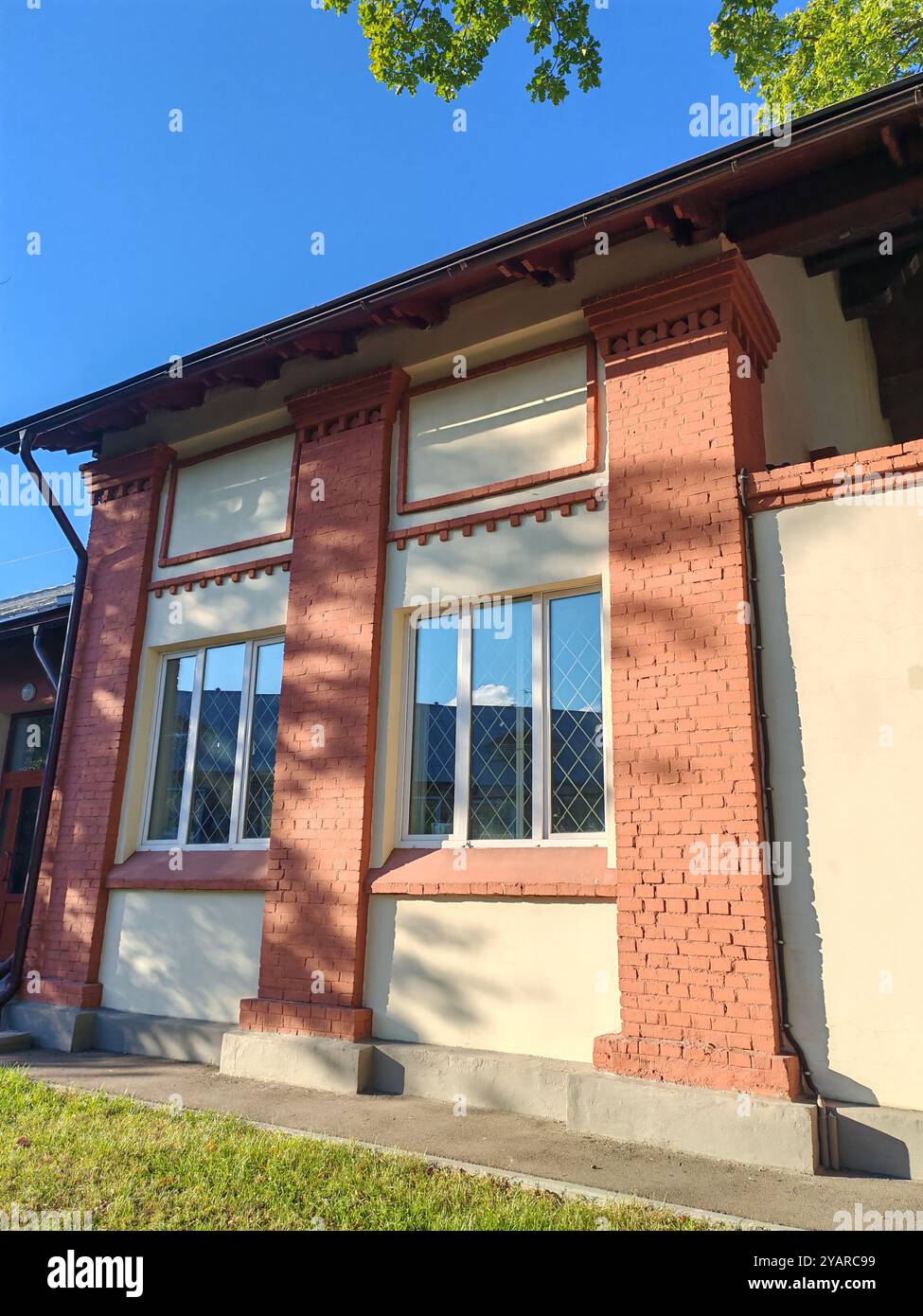 A vintage building with distinctive red brick columns and a spacious ...