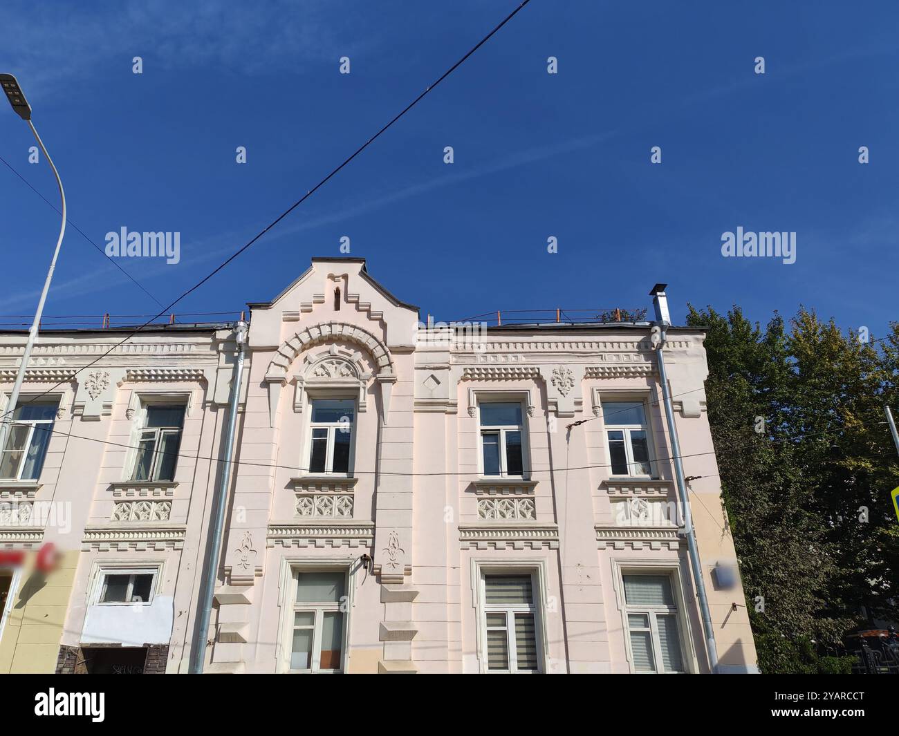 two-story classical building with intricate architectural details ...