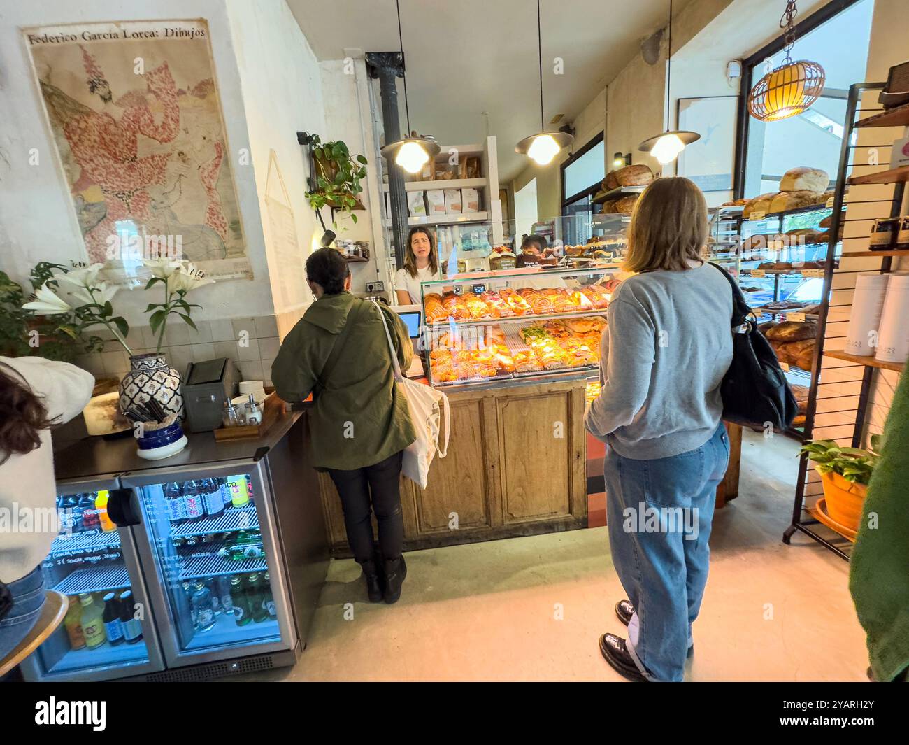 Costumers cue in Alma Nomad Bakery, Madrid, Spain Stock Photo - Alamy