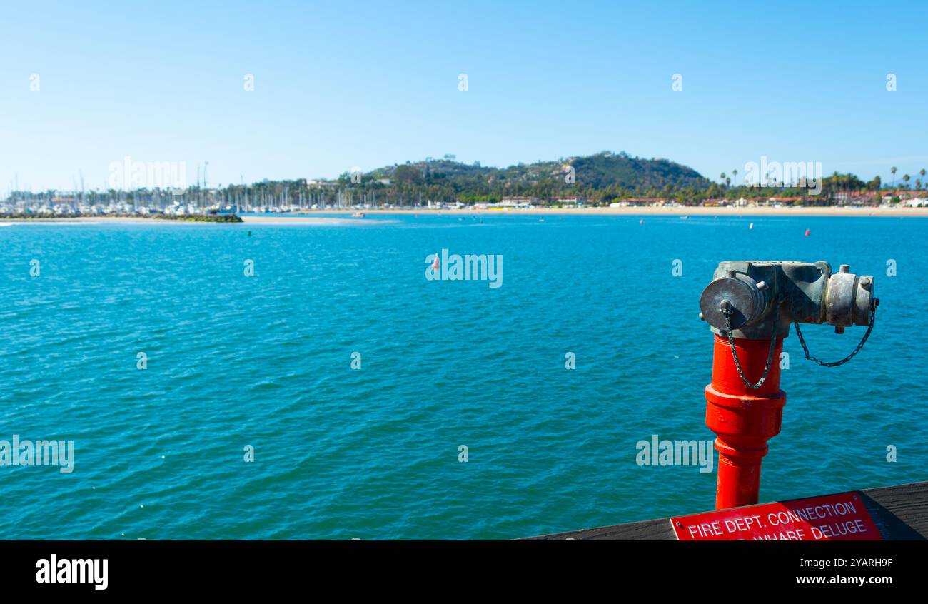 Fire Hydrant in Santa Barbara pier with the shoreline on the background ...