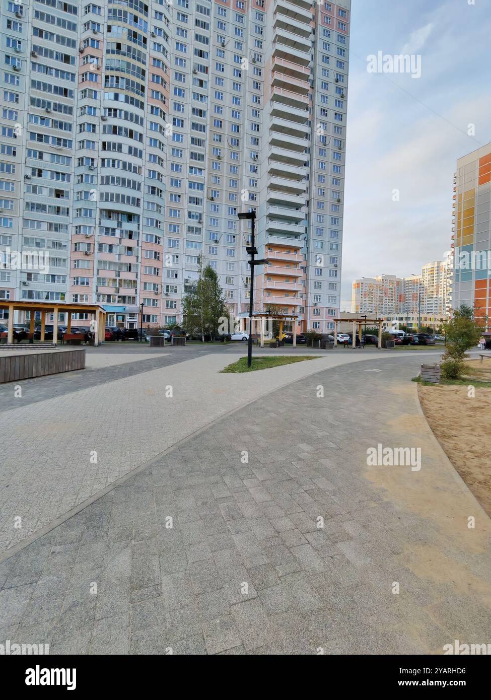 A large multi-story residential building with a pastel color palette of ...