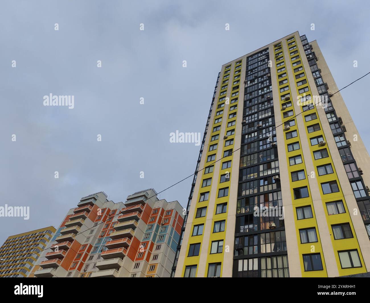 A towering residential building with pastel accents, featuring a wide ...