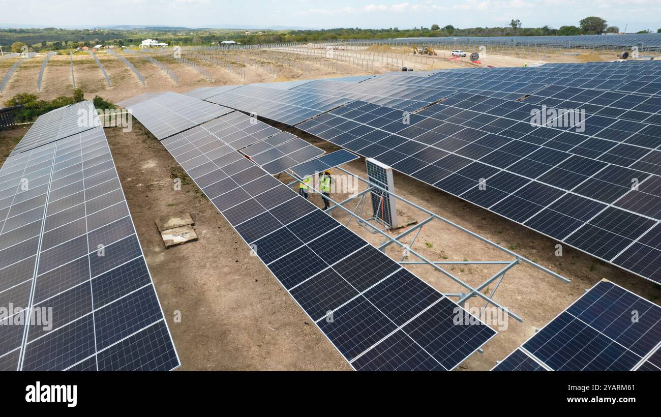 Drone picture of mens working in a modern utility scale solar farm ...