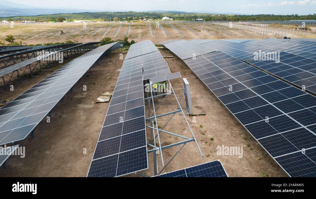 Drone picture of mens working in a modern utility scale solar farm ...