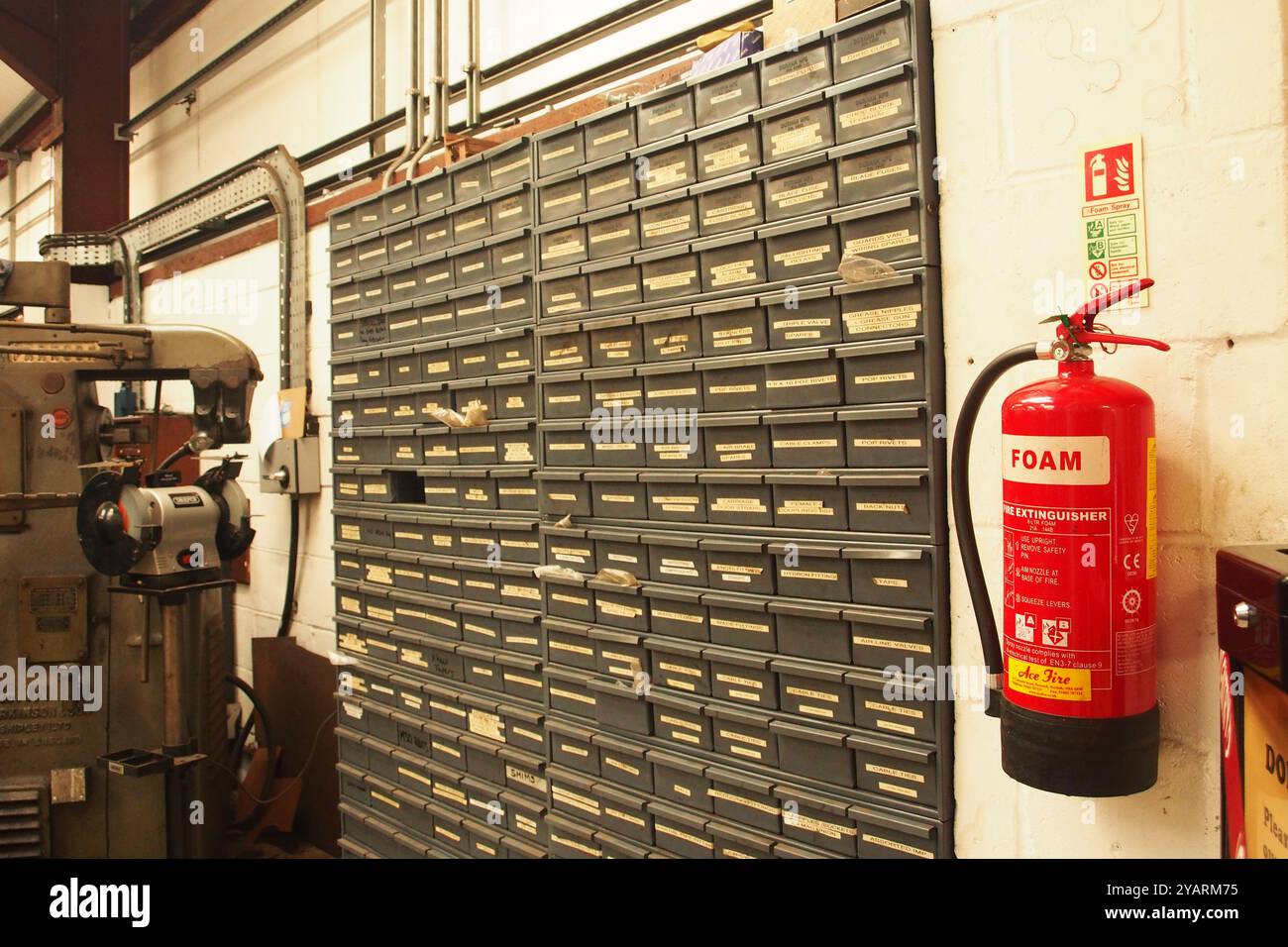 Inside of a mechanical workshop showing the labelled drawers for many ...