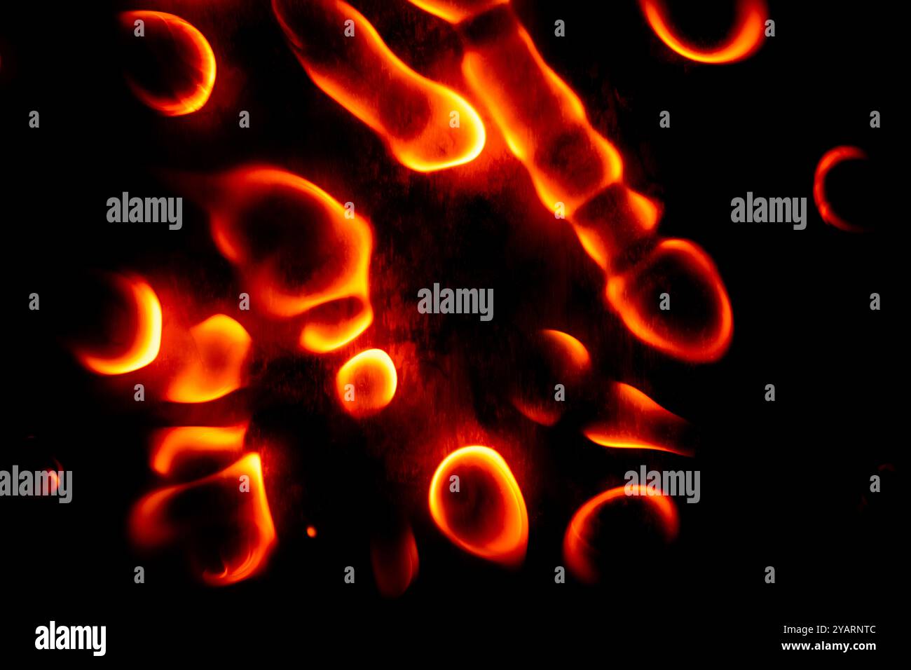 Beautiful liquid red, orange fire texture on black background. Fire in ...