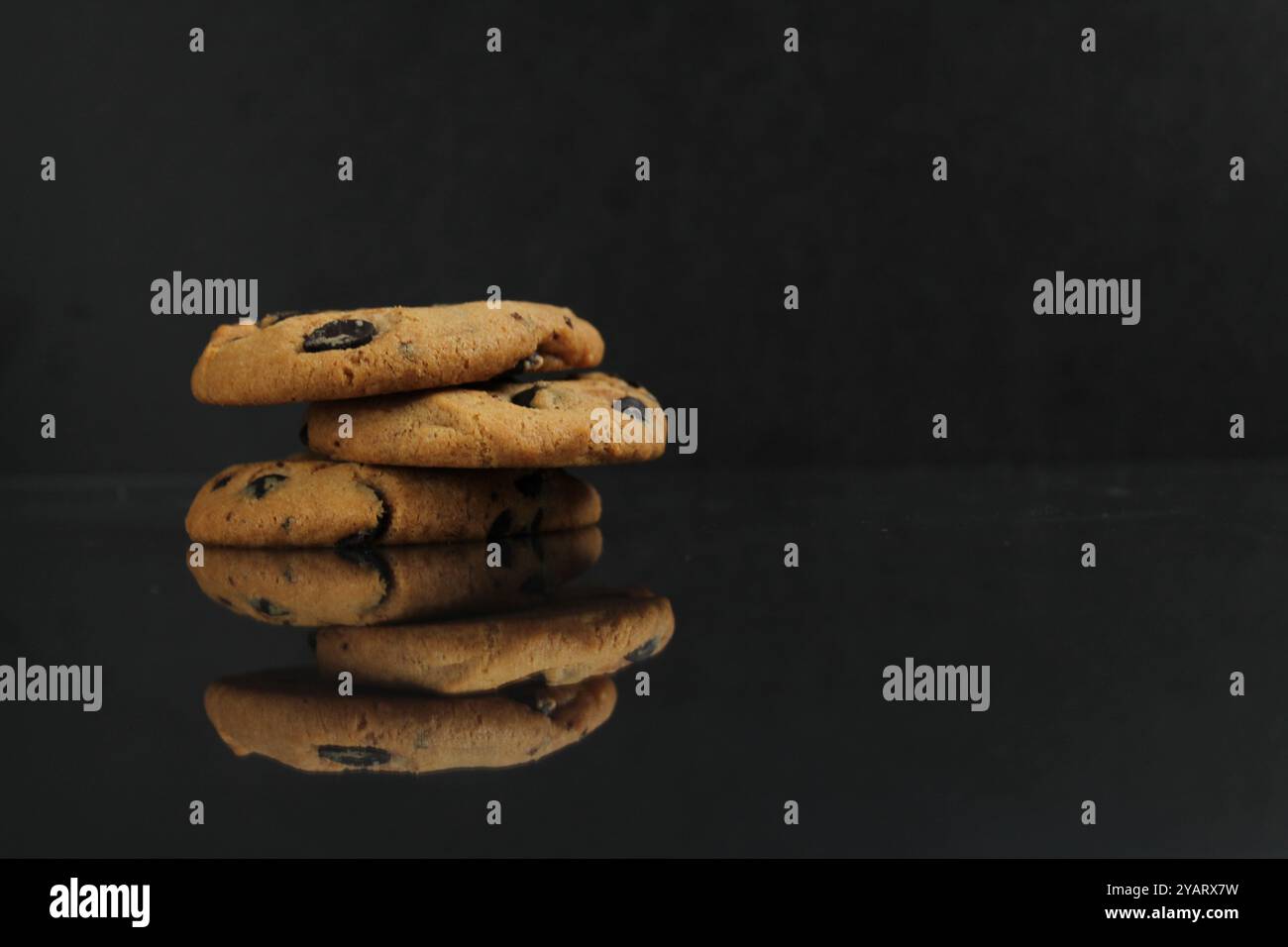 cookies with chocolate chips side view with reflection on black ...