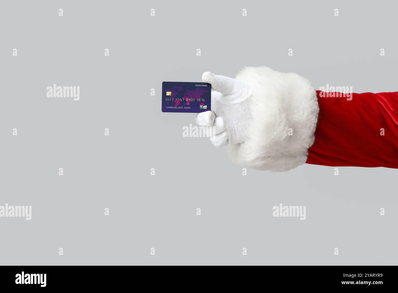 Santa Claus with credit card on grey background Stock Photo - Alamy