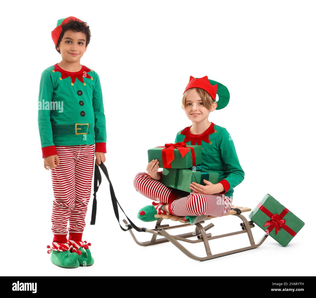 Cute little children in elves costumes with sledge and gift boxes ...