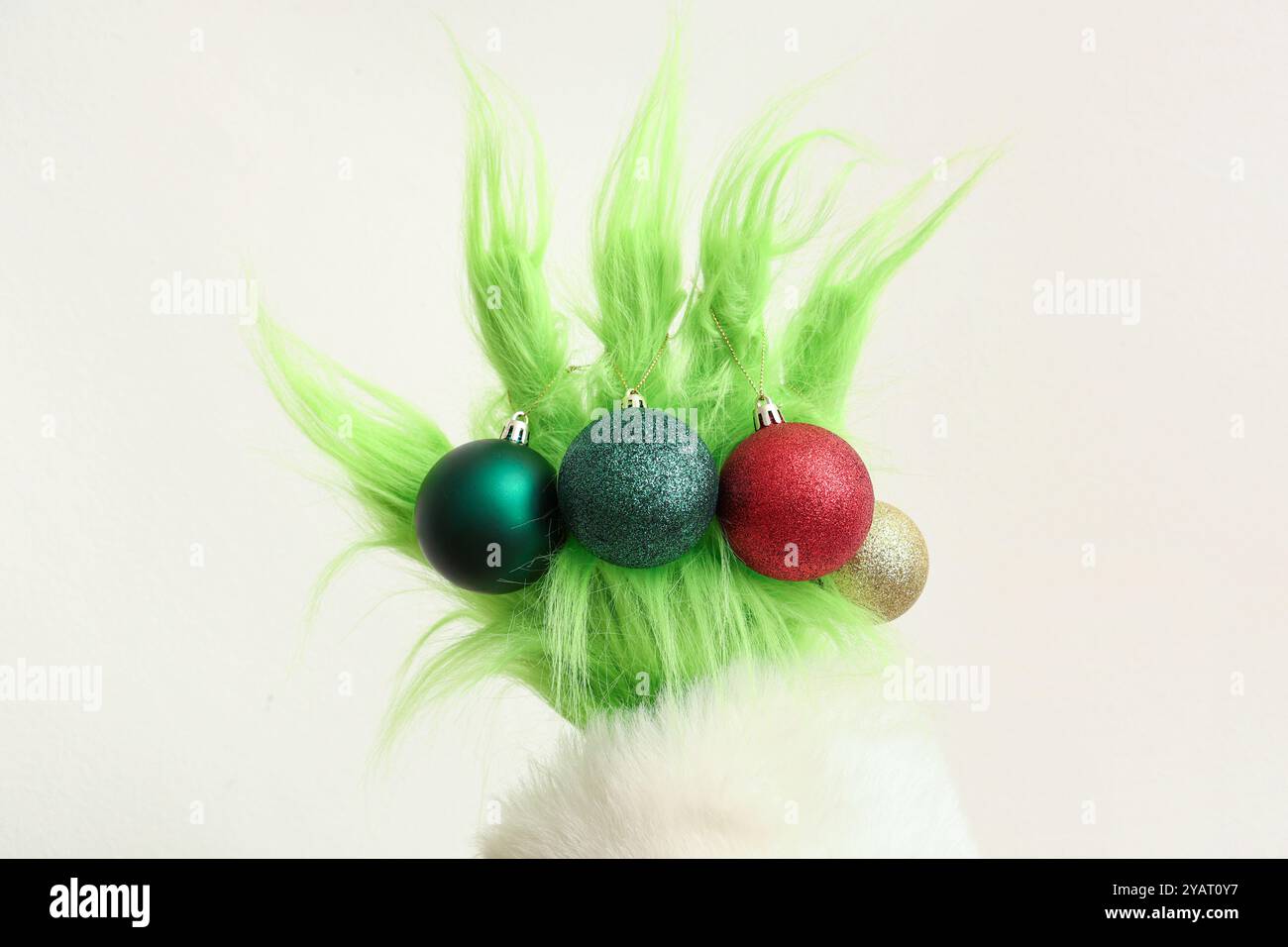 Green hairy hand of creature in Santa costume with Christmas balls on ...