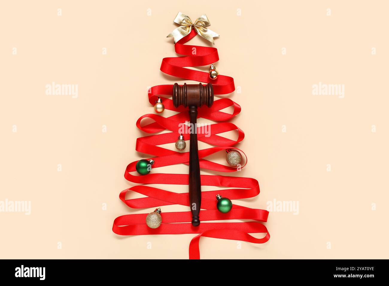Christmas tree made of red ribbon, judge gavel and decorations on color ...