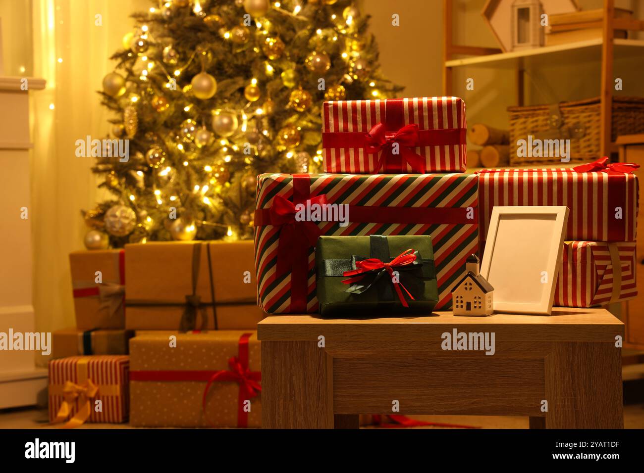 Christmas presents with frame on table in living room at night Stock ...