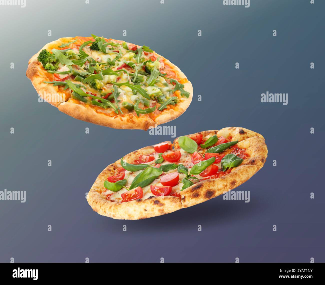 Different pizzas in air on gradient background Stock Photo - Alamy