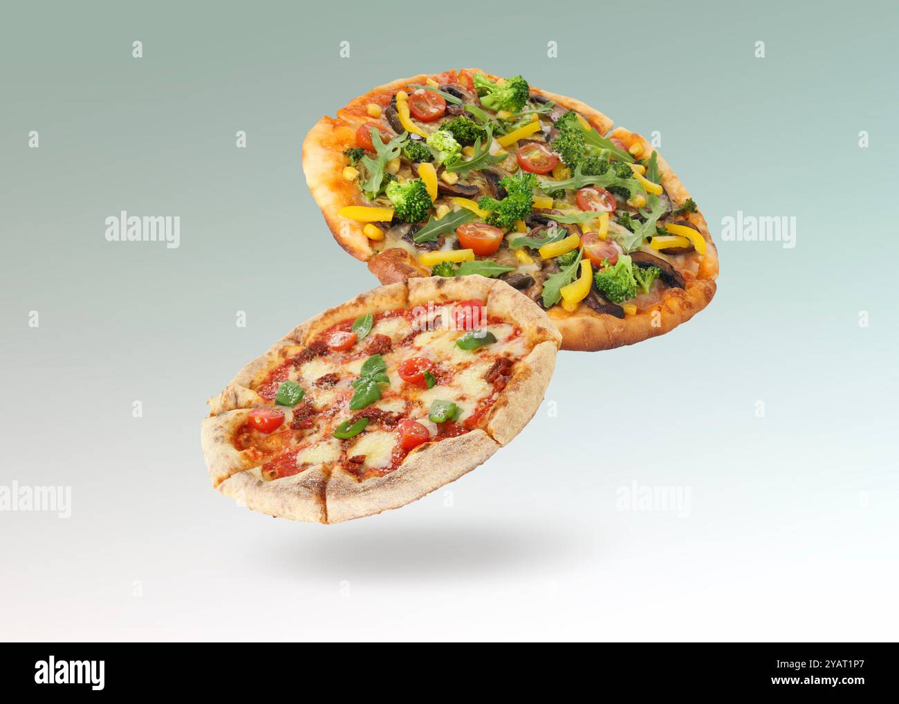 Different pizzas in air on gradient background Stock Photo - Alamy