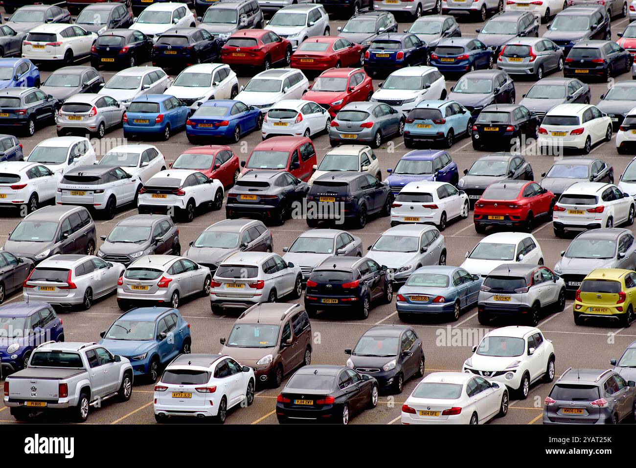 An oblique panoramic view of a congested car park full of regimented ...