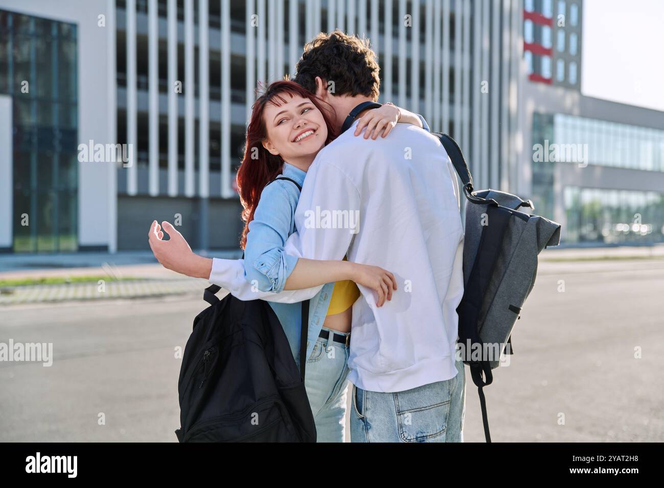 Teenage friends meeting, college students teenage guy and girl hugging ...