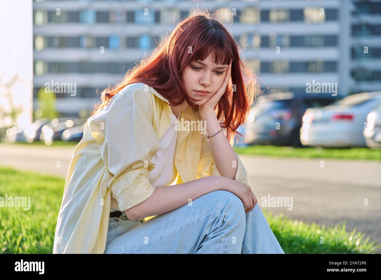 Upset sad unhappy young female sitting outdoor Stock Photo - Alamy