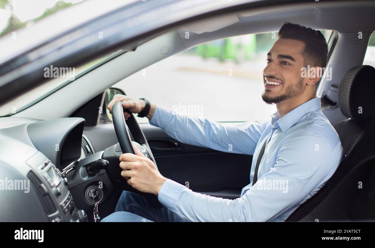 Excited arab guy going to office, driving his car Stock Photo - Alamy