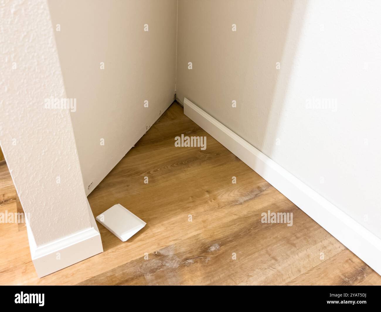 Installing White Vinyl Baseboards and Trim Pieces in a Room Under ...