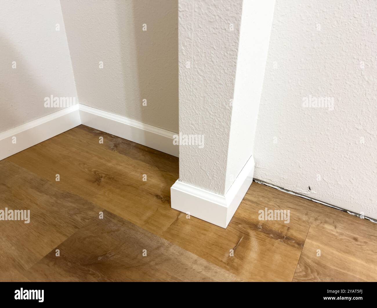 Installing White Vinyl Baseboards and Trim Pieces in a Room Under ...