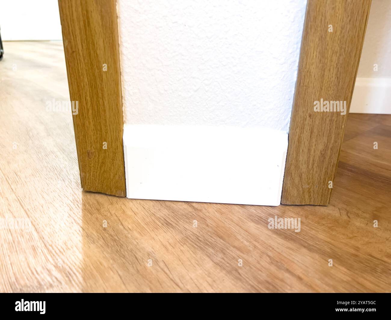 Installing White Vinyl Baseboards and Trim Pieces in a Room Under ...