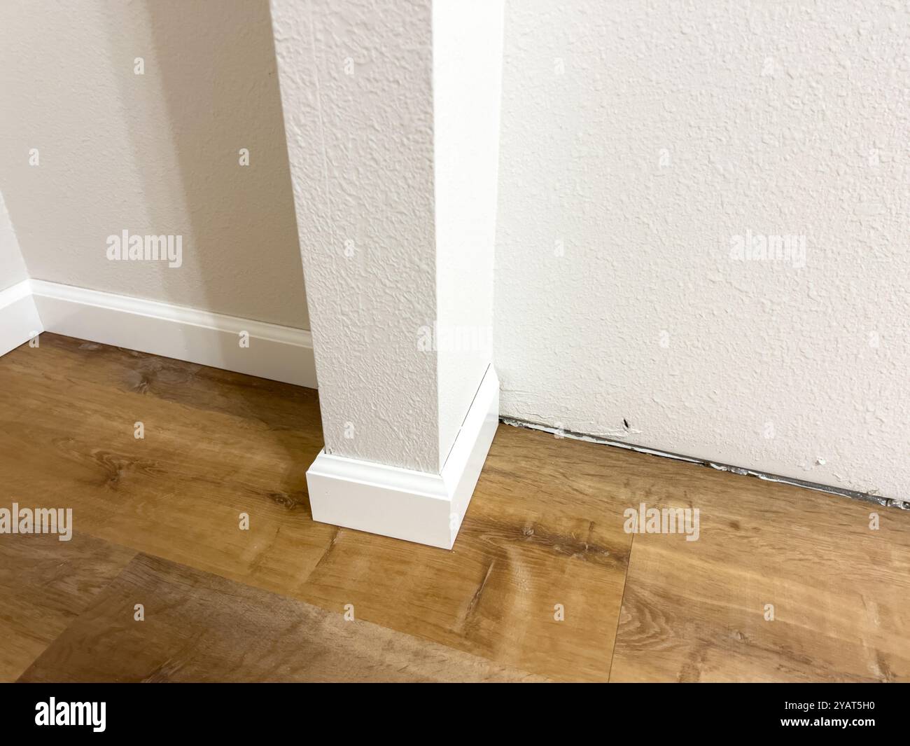 Installing White Vinyl Baseboards and Trim Pieces in a Room Under ...