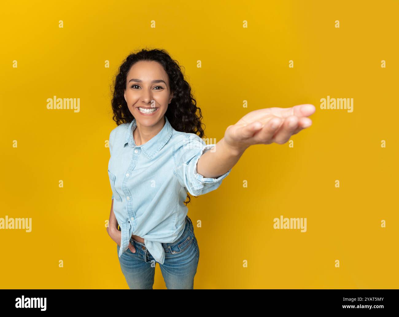 Young woman presenting something with open hand hi-res stock ...