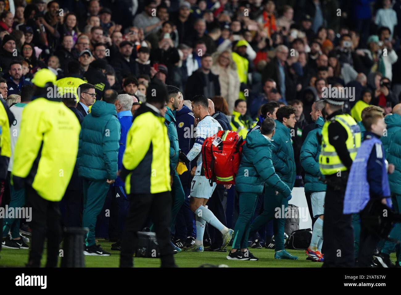 Portugal's Cristiano Ronaldo (centre) leaves the pitch through a crowd ...