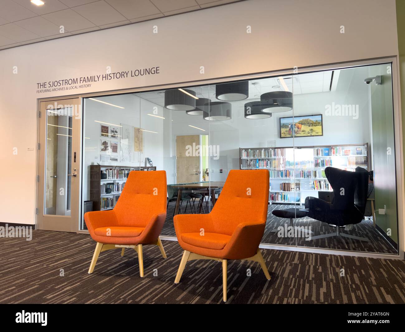 Modern Library Lounge with Bright Orange Chairs and Glass-Enclosed ...
