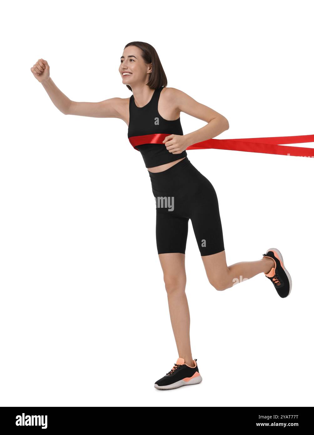 Beautiful woman in sportswear crossing red finish line on white ...