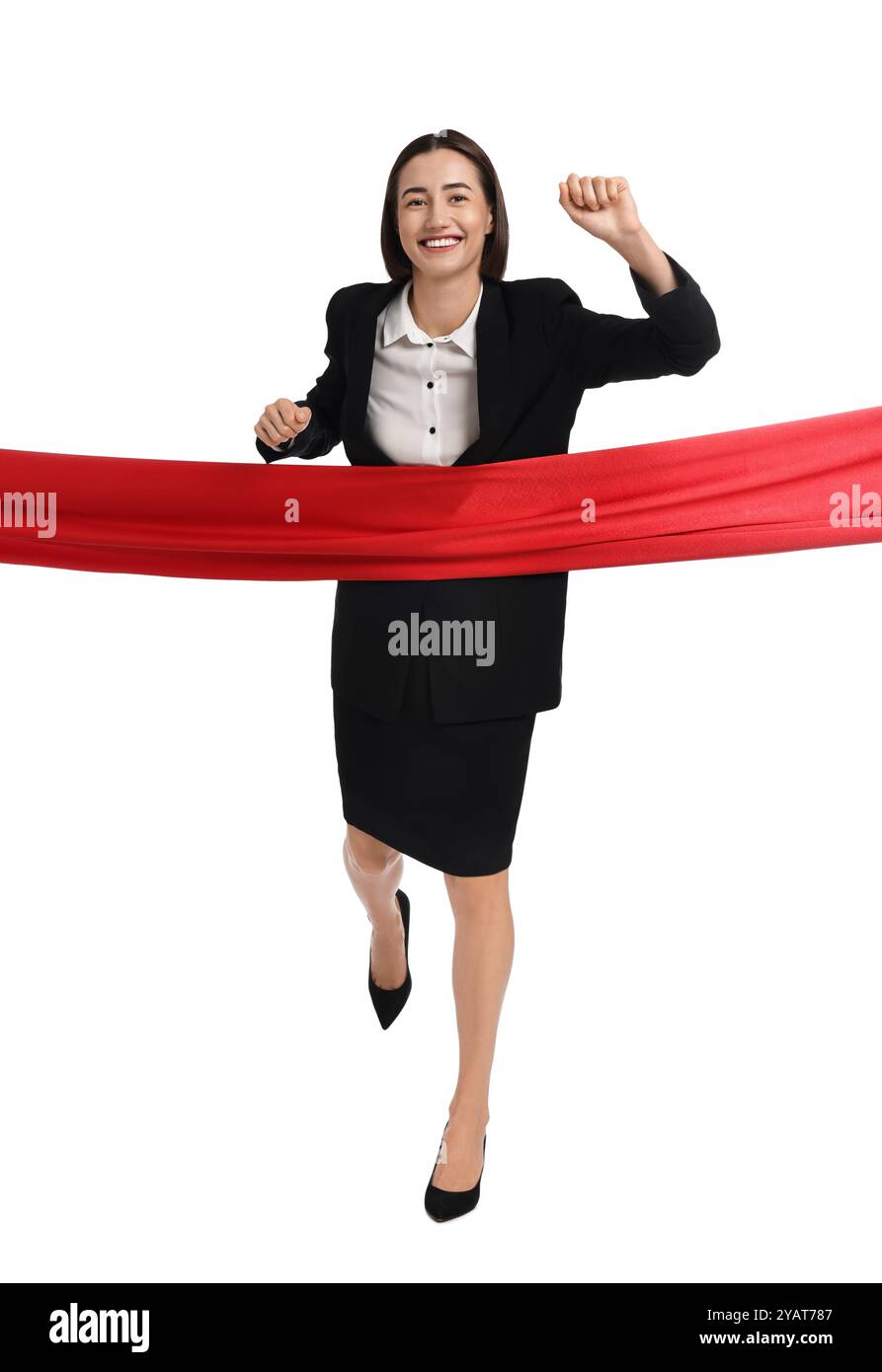 Young businesswoman in suit crossing red finish line on white ...