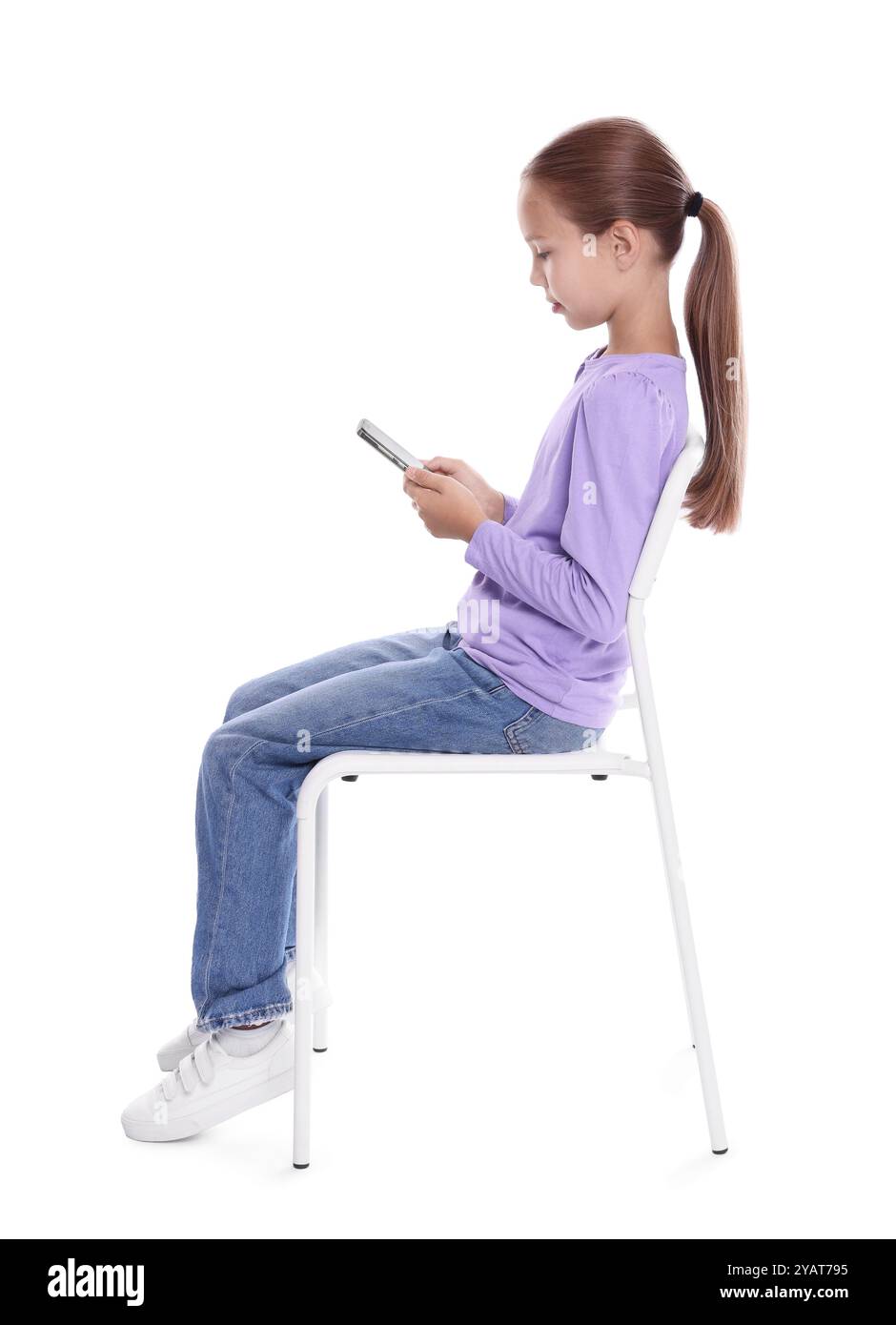 Girl with correct posture and smartphone sitting on white background ...
