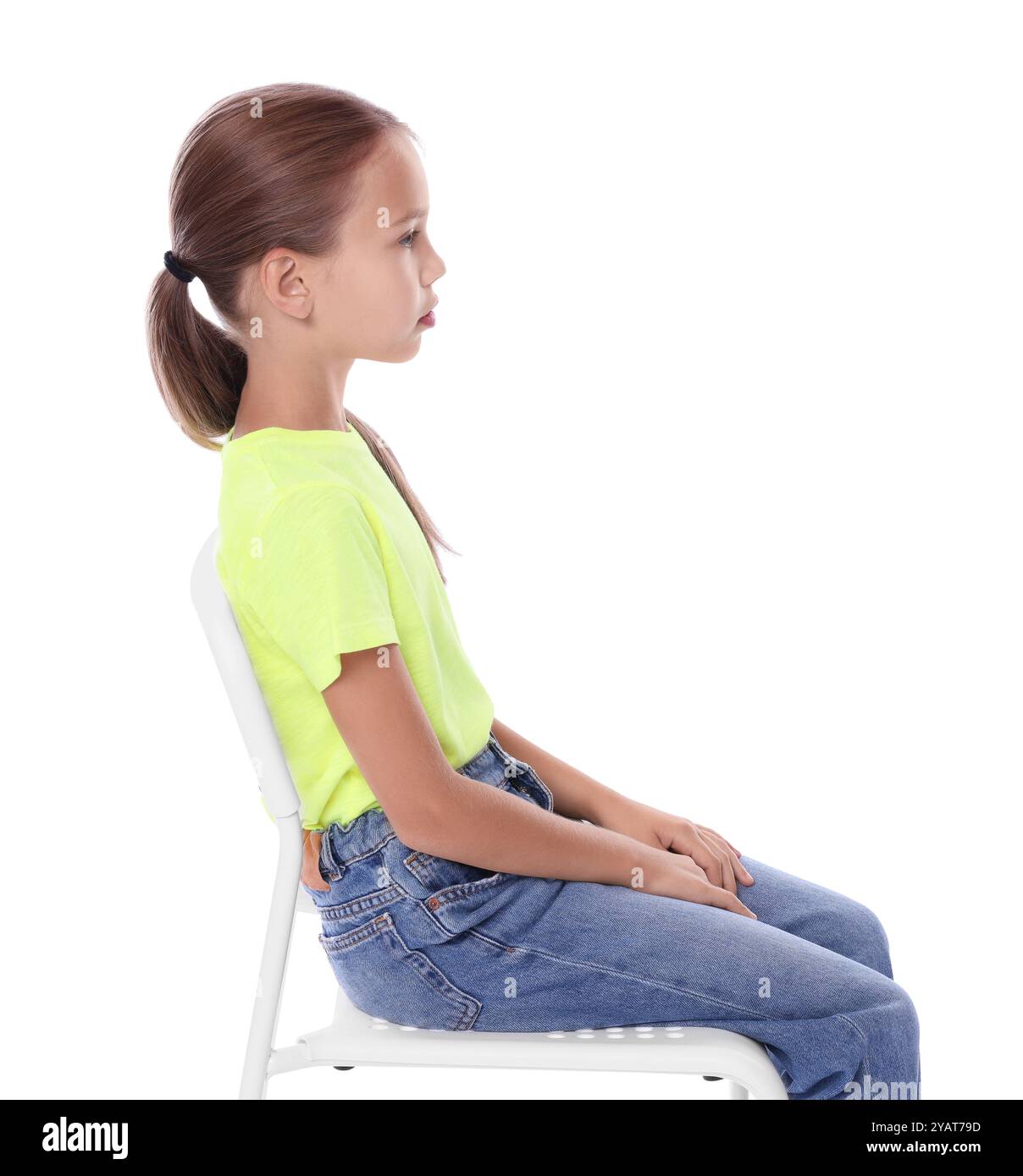 Girl with correct posture sitting on chair against white background ...