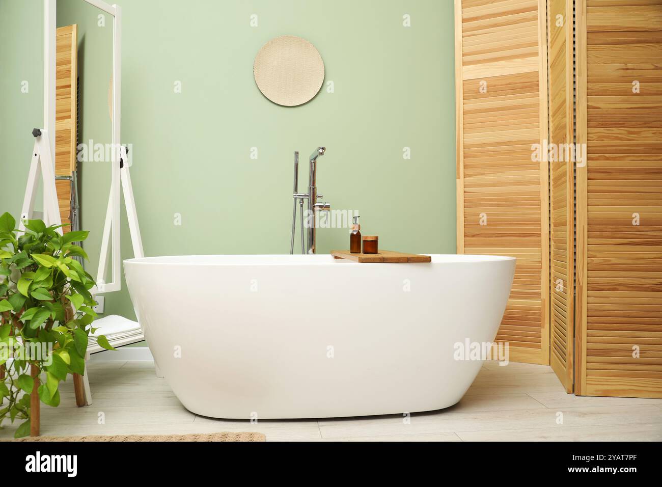 Stylish bathroom interior with folding screen and tub Stock Photo - Alamy
