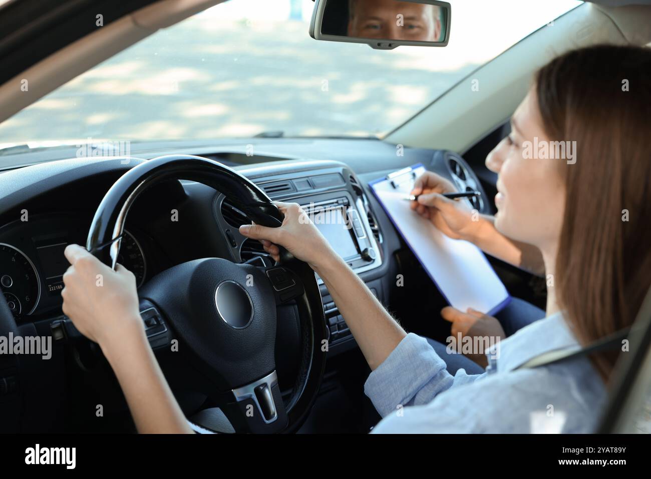 Driving school. Student passing driving test with examiner in car Stock ...