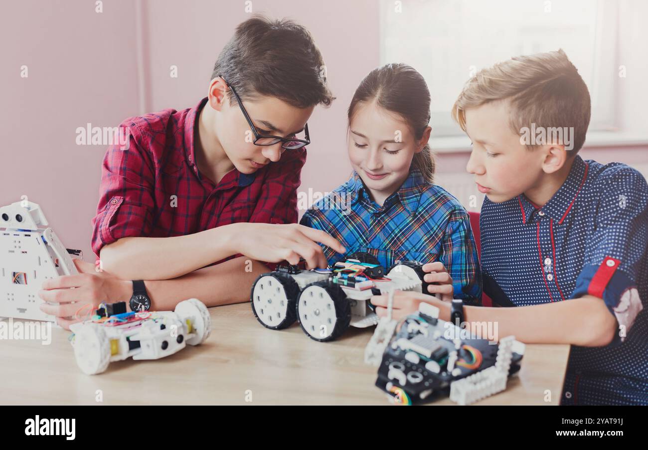 Stem education. Kids creating robots at school Stock Photo - Alamy