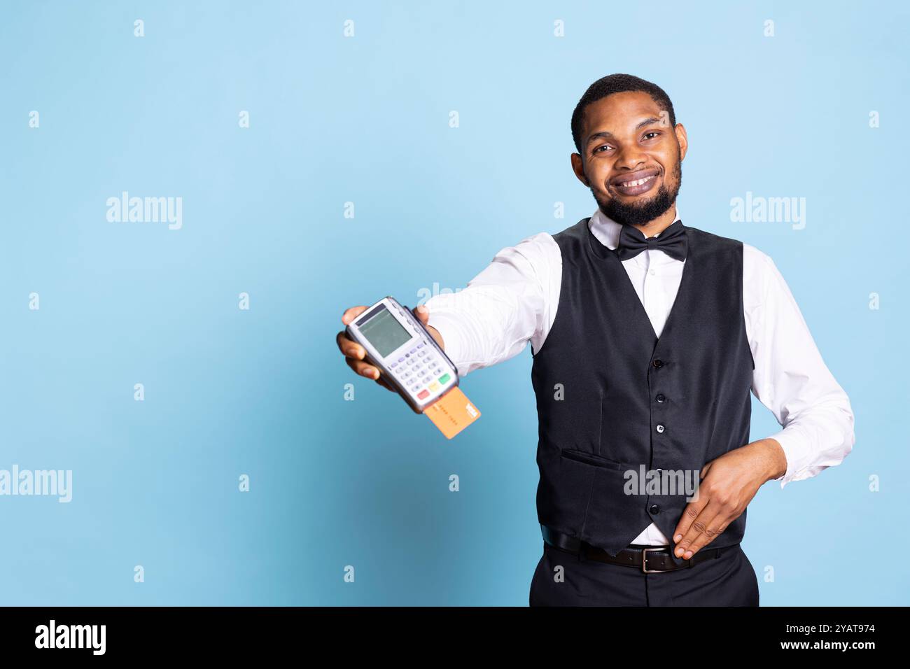 Professional hotel porter presenting the pos terminal and credit card ...