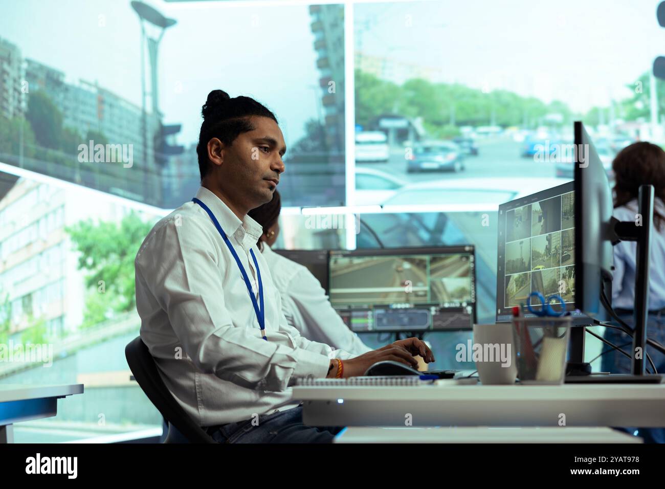 Indian man works on monitoring real time surveillance footage from ...