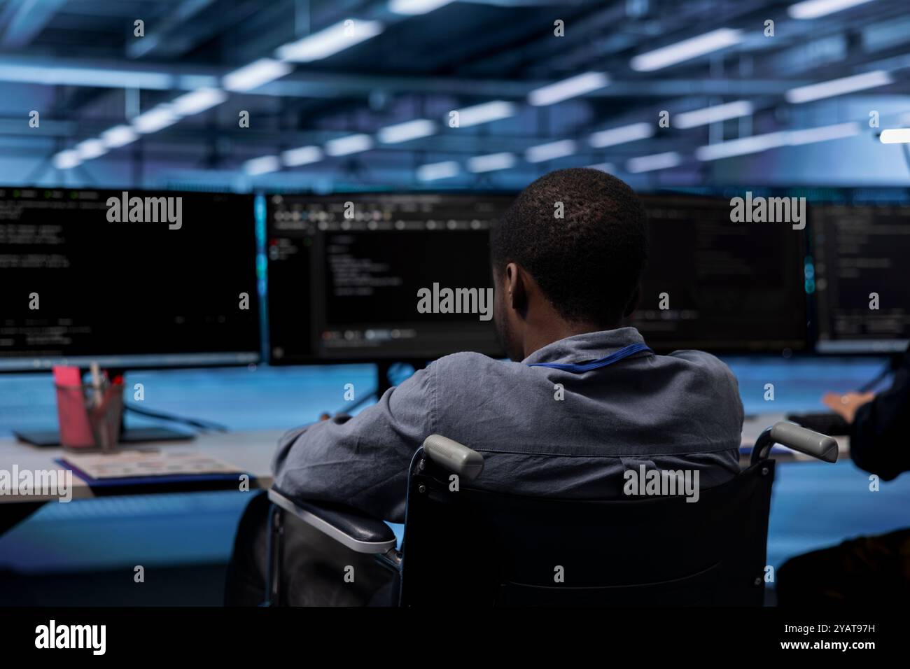 African american person with paraplegia working in inclusive server ...