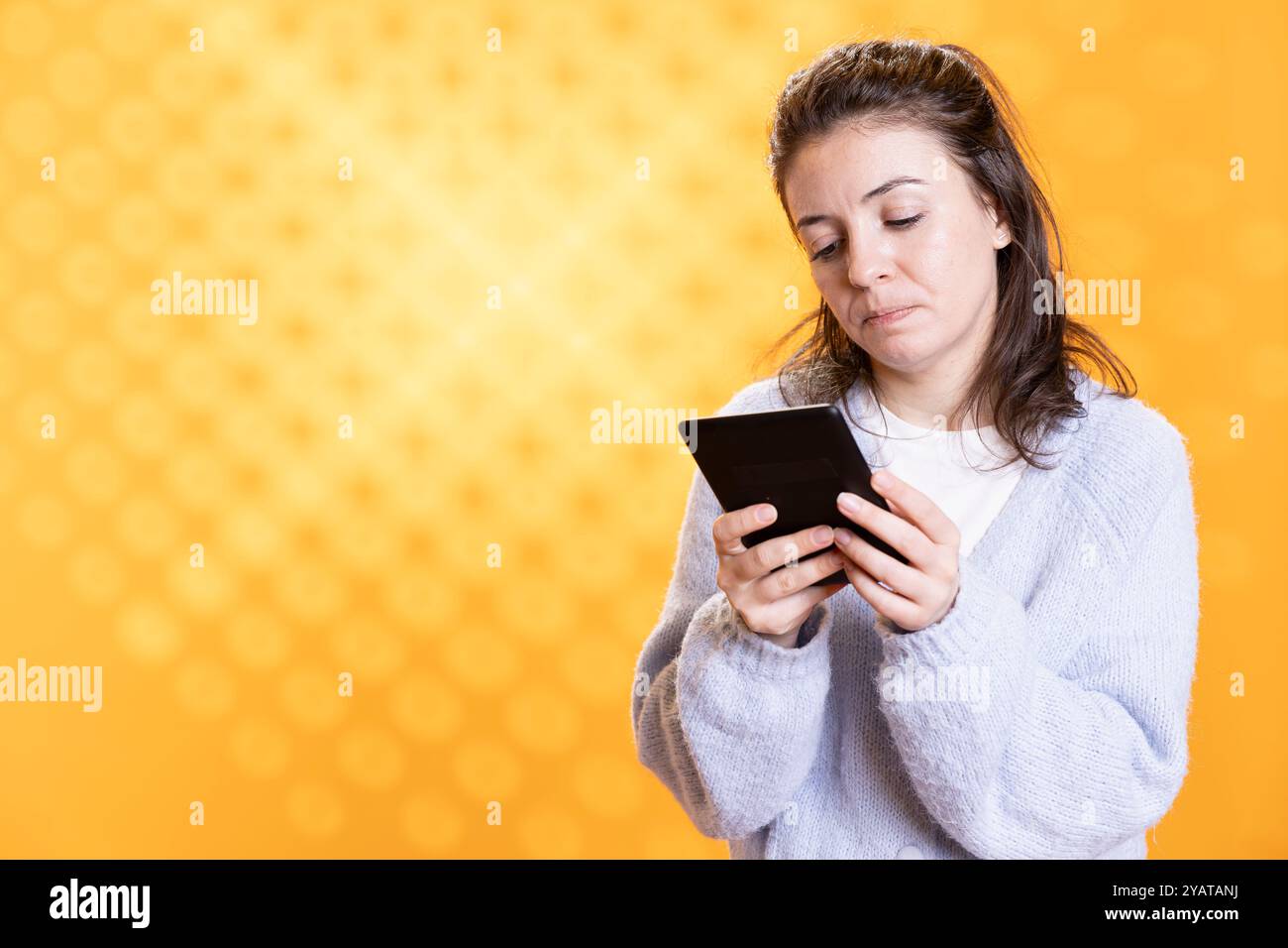 Person with sad facial expression reading ebook on ereader, gathering ...