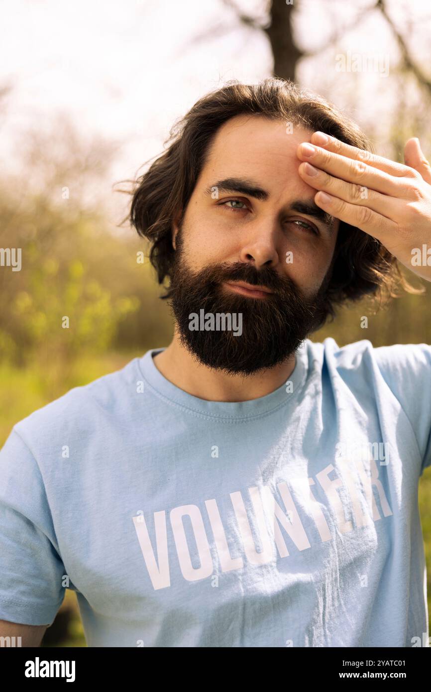 Portrait of exhausted young activist doing voluntary work, digging ...