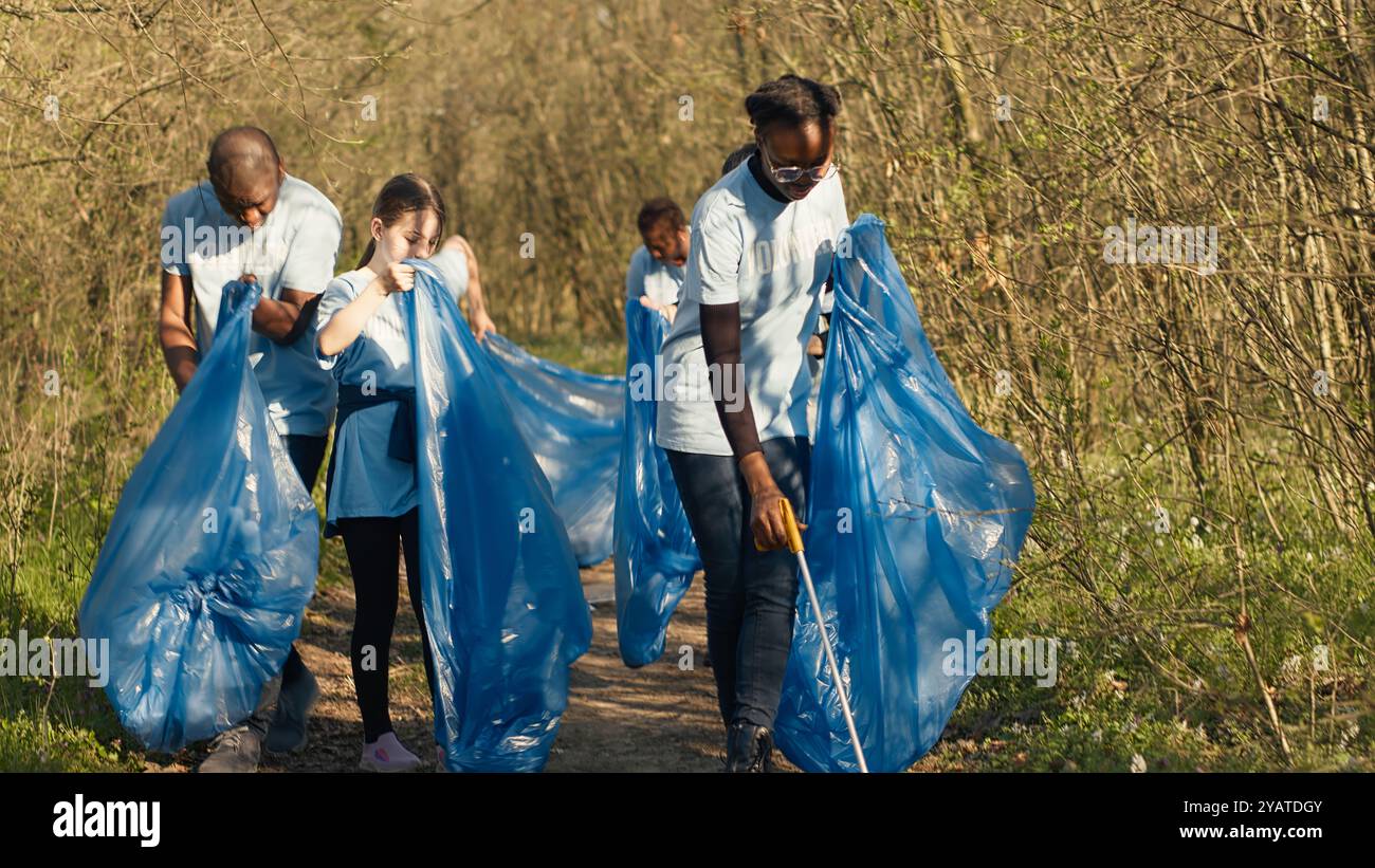 Group of volunteers working to clean the forest from garbage ...