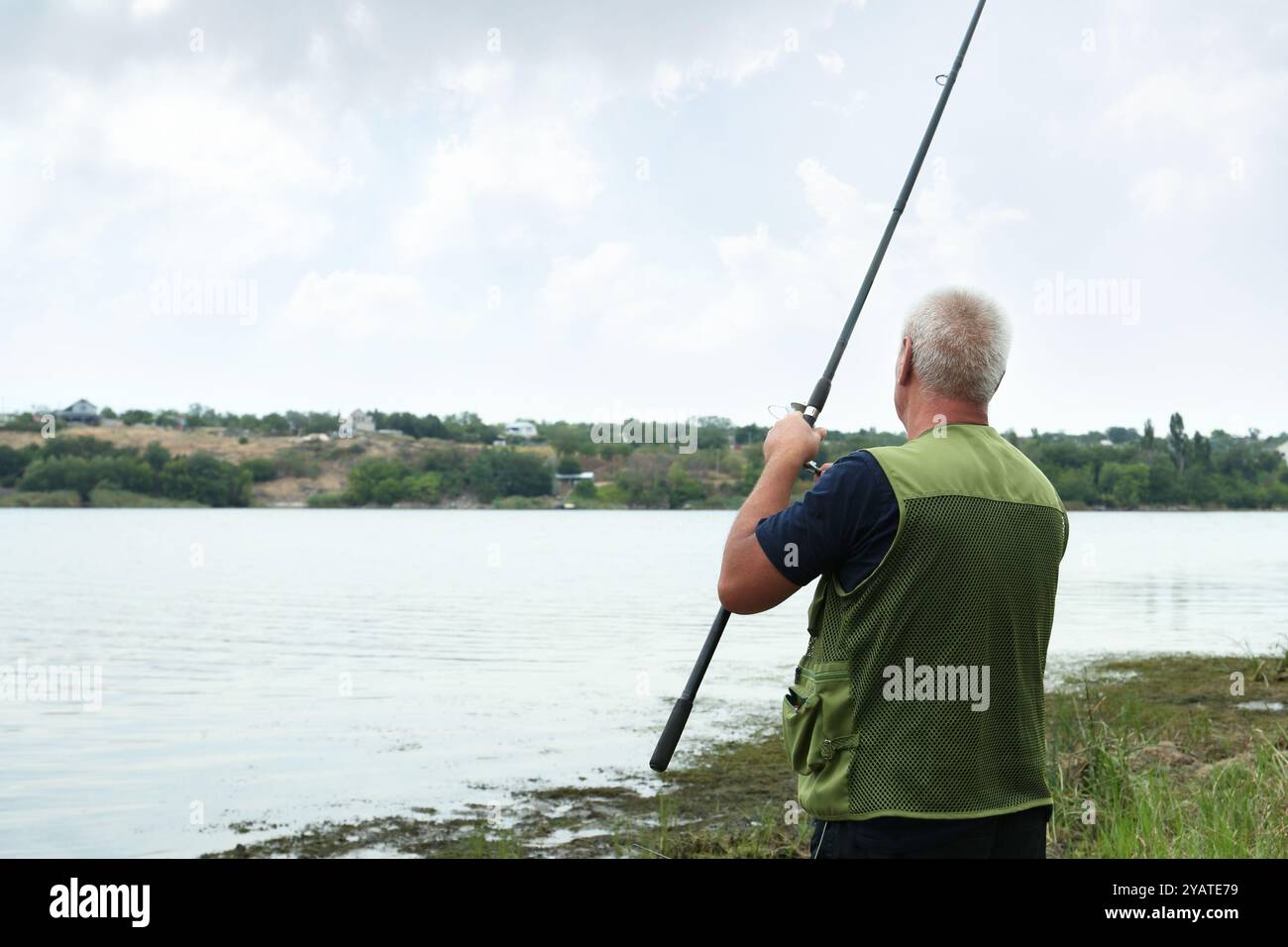 Back view man holding fishing hi-res stock photography and images - Alamy