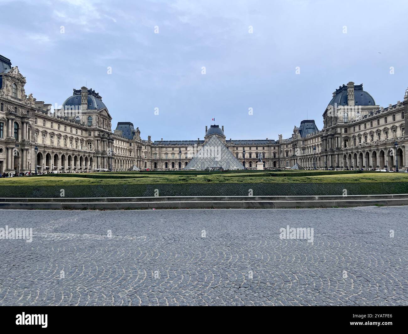 Wide angle photo of the Louvre Museum in Paris. Showing the cobblestone ...