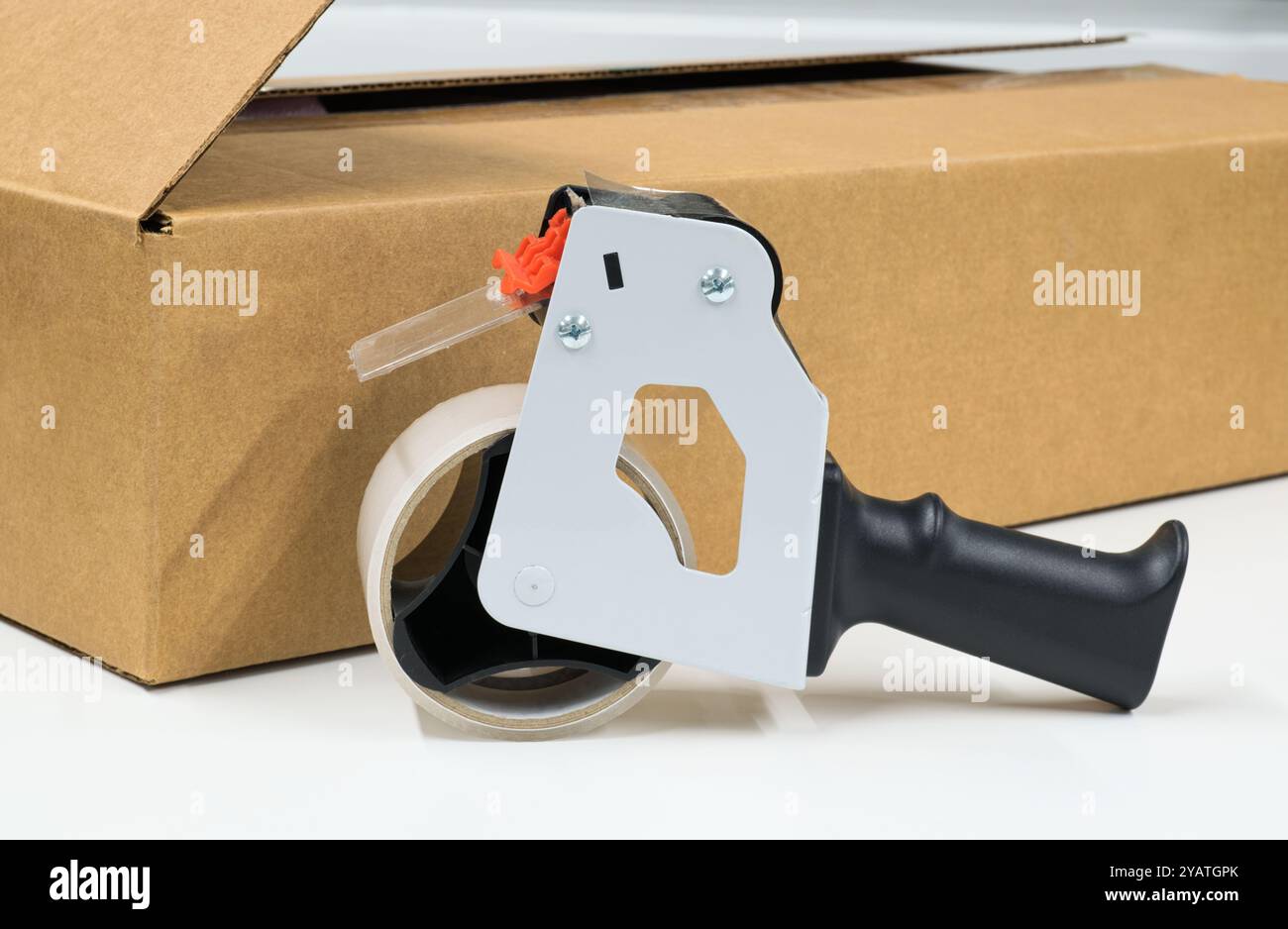 Tape gun dispenser and cardboard box shipping concept with copy space ...