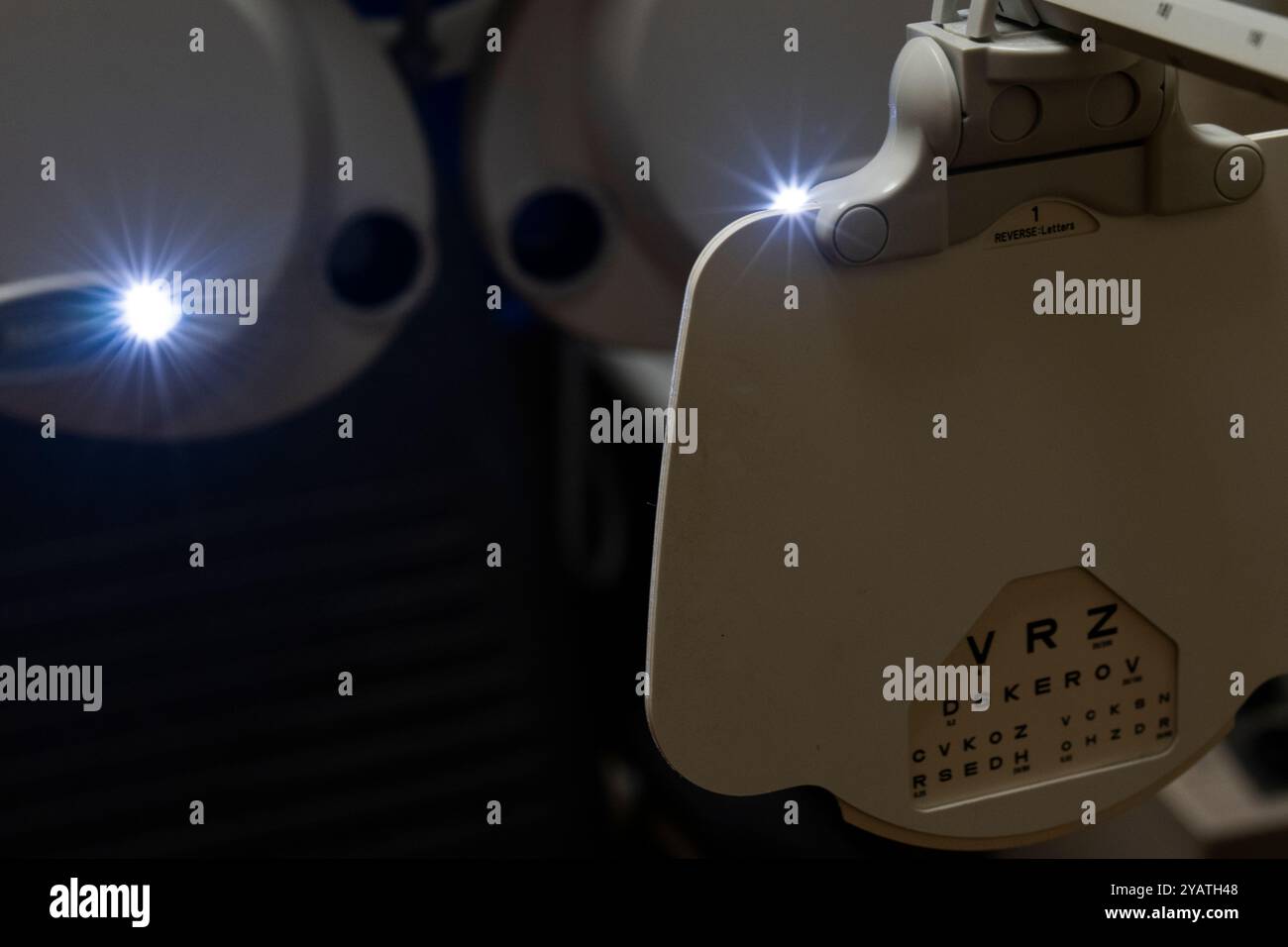 Lights from a phoropter, which is used to determine a person's vision ...